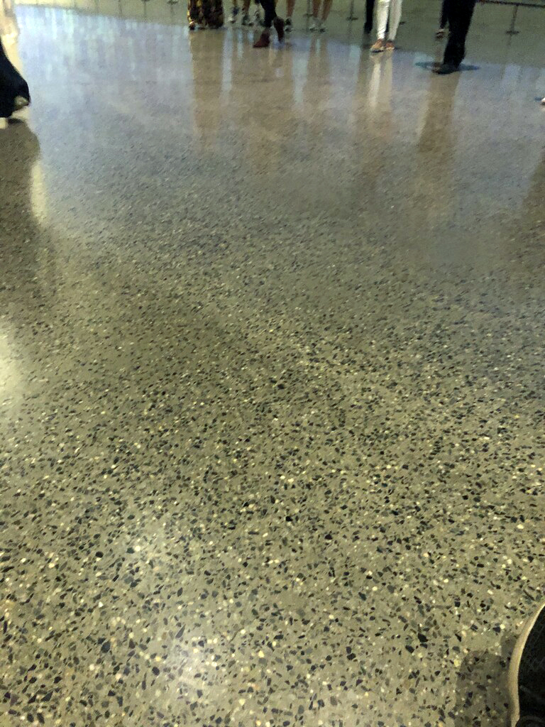 ambiXes Museum, high ceiling, busy, people walking by, stone floor ...